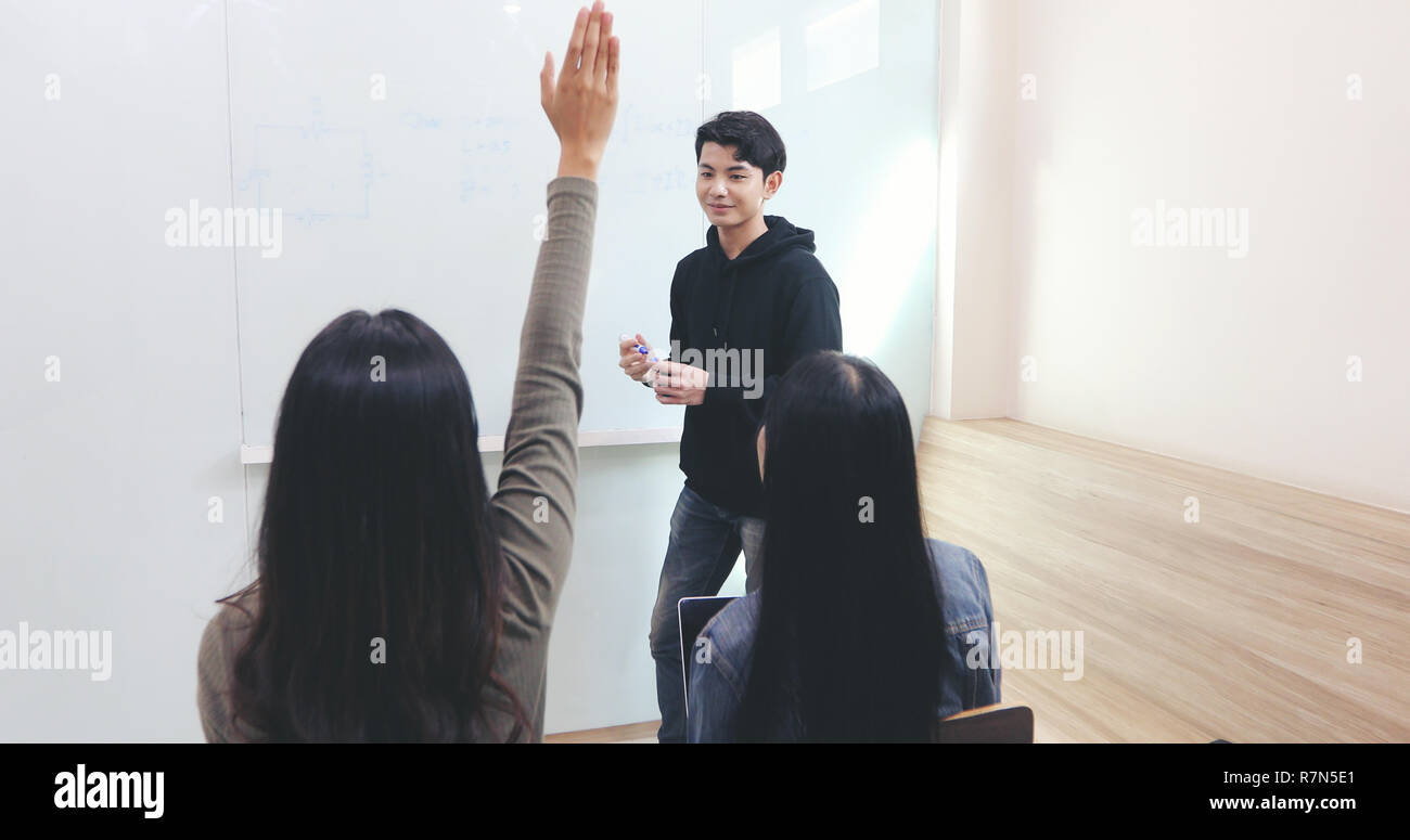 Group Students raise their hands to ask a friend questions for teaching ...