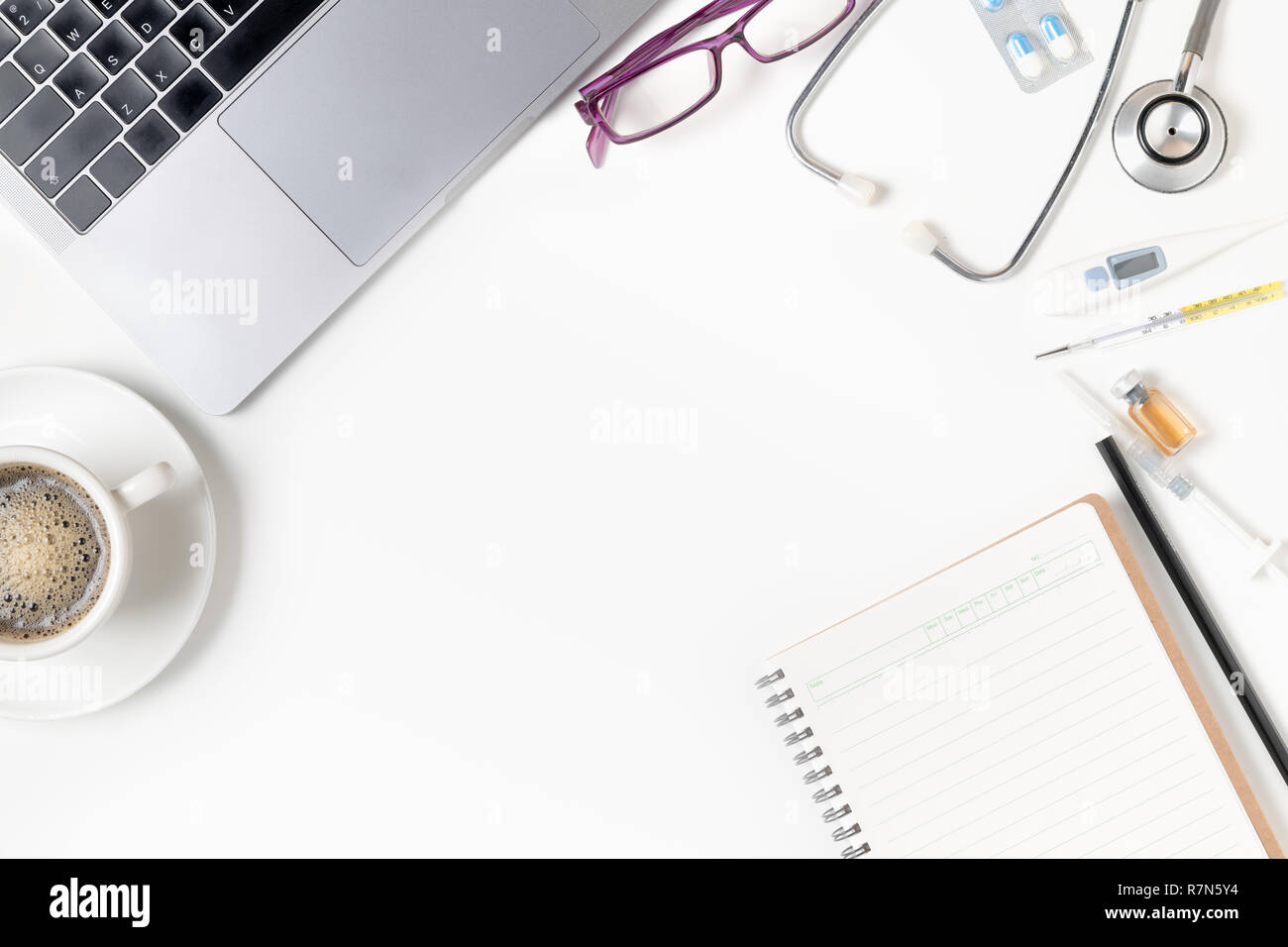 Top view of doctor desk table with stethoscope, coffee and laptop. Top ...