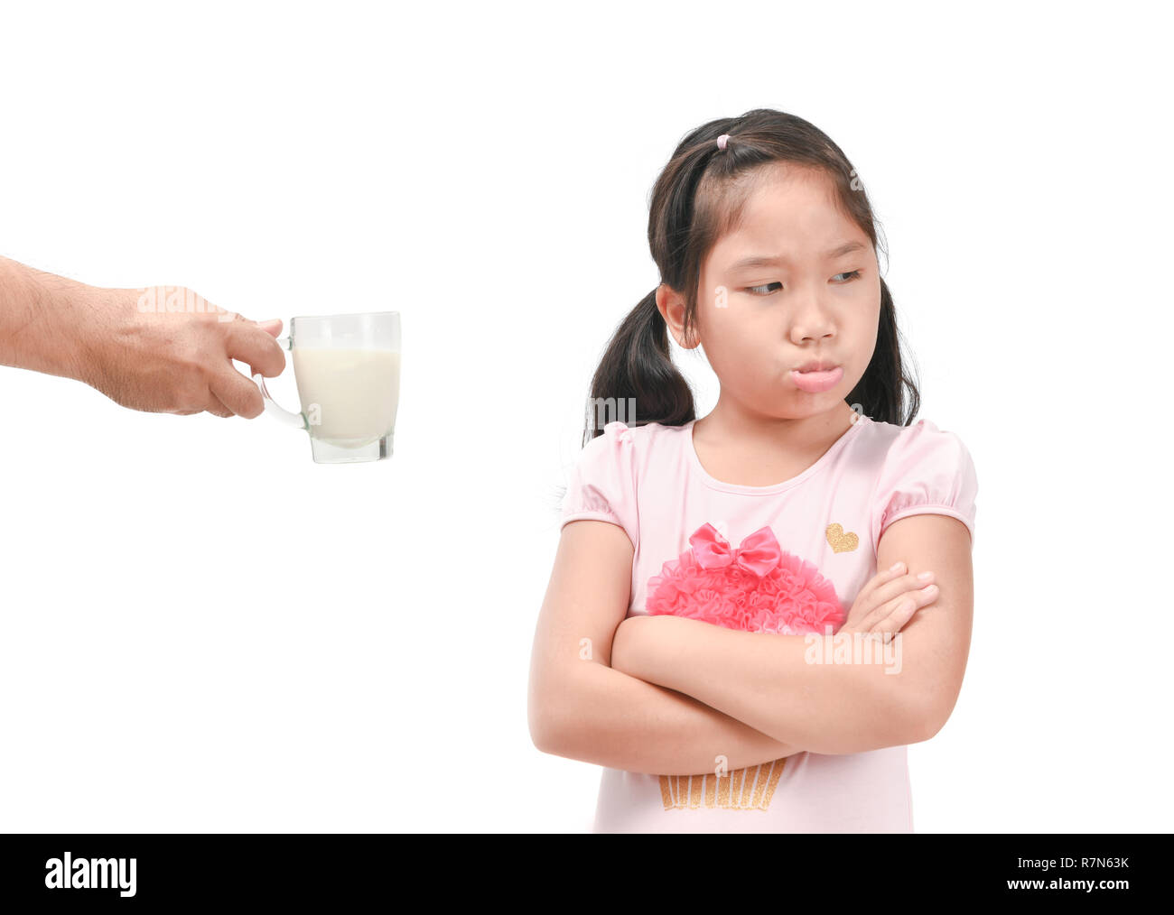 Sad girl refuses drink a fresh milk isolated on white background ...