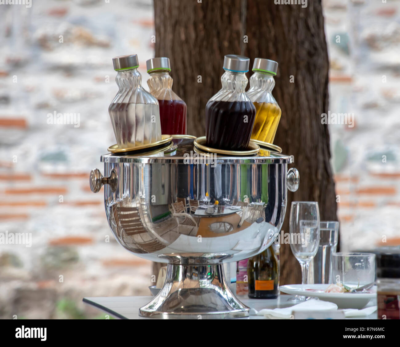 Cooling bottles with alcohol on the table set for dinner. The cooler ...