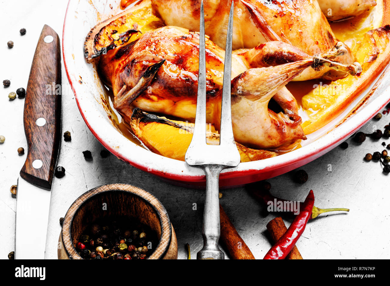 Carcasses of quail roasted with orange sauce Stock Photo - Alamy