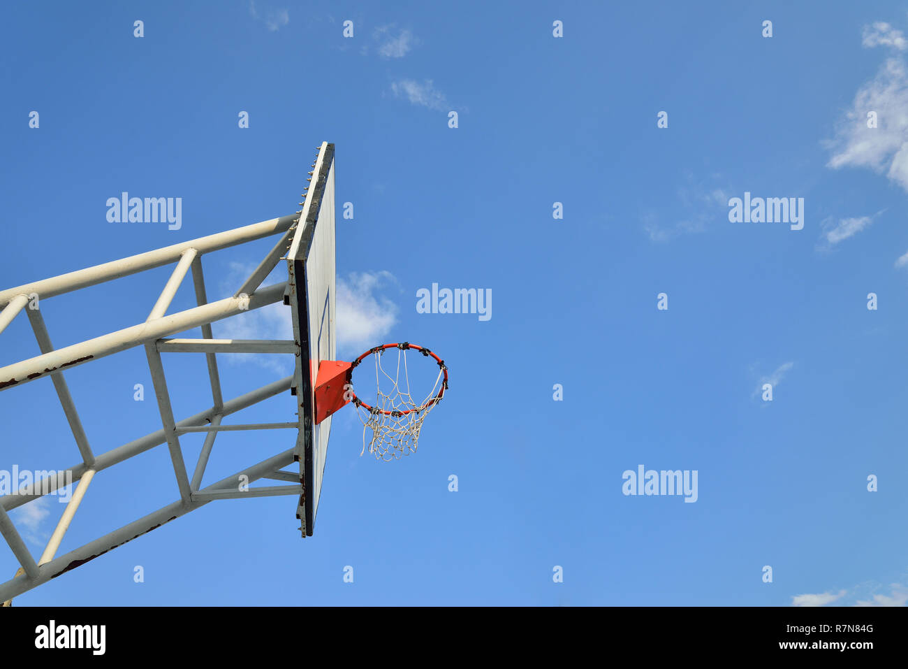 Basketball hoop with blue sky background Stock Photo - Alamy