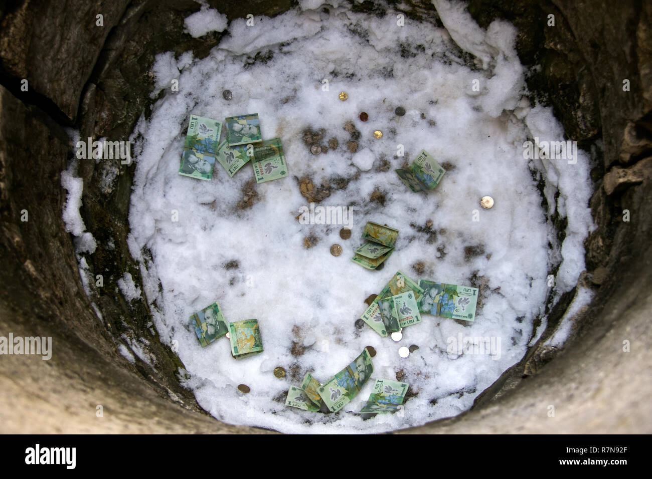 Money dropped in a well, Bran castle, Romania Stock Photo - Alamy