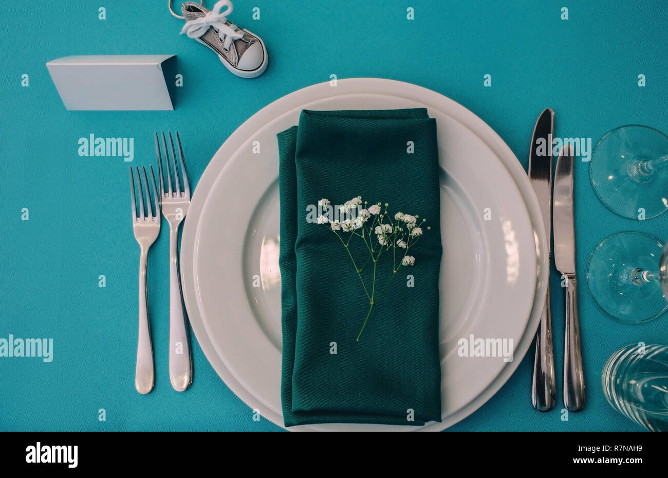 Dinner plate setting on a turquoise table , top view Stock Photo - Alamy