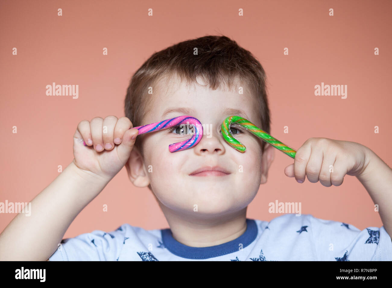 A cute boy holding two candy sticks. Striped Candy Cane Stock Photo - Alamy