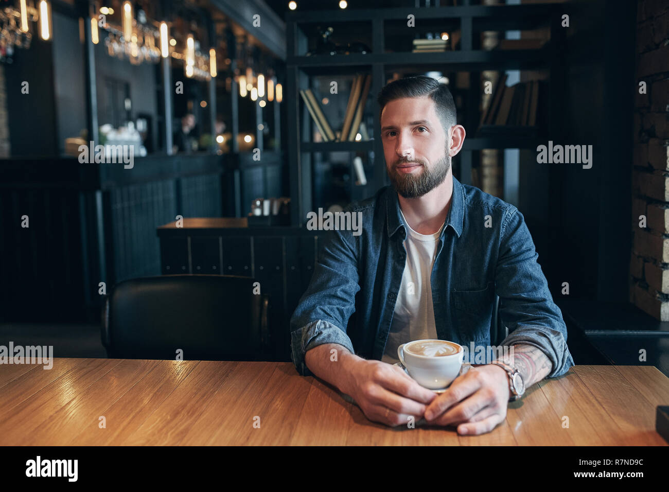 Confident man enjoying a cup of coffee while having work break lunch in ...