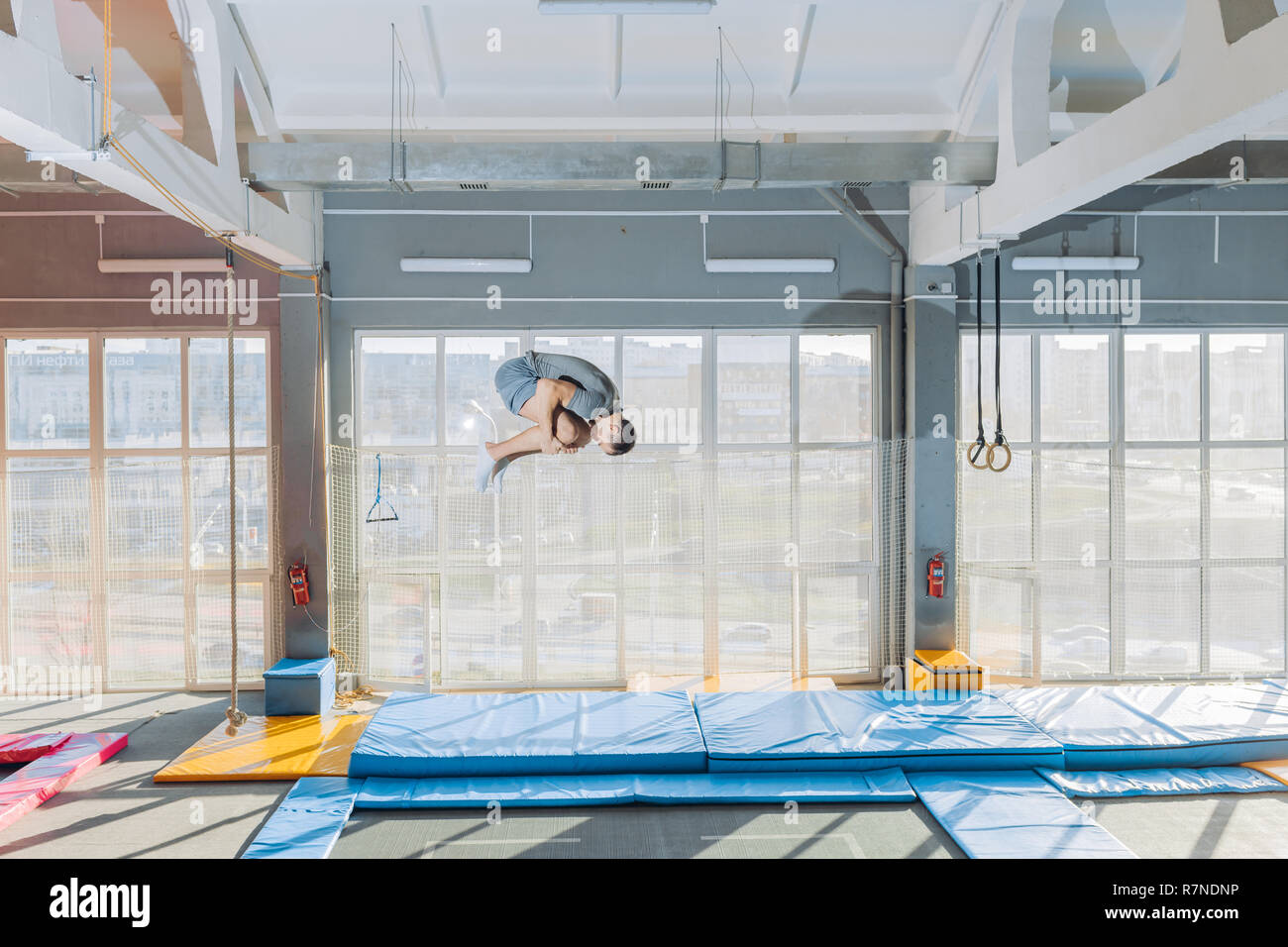 flexible guy doing flip over the mat Stock Photo - Alamy