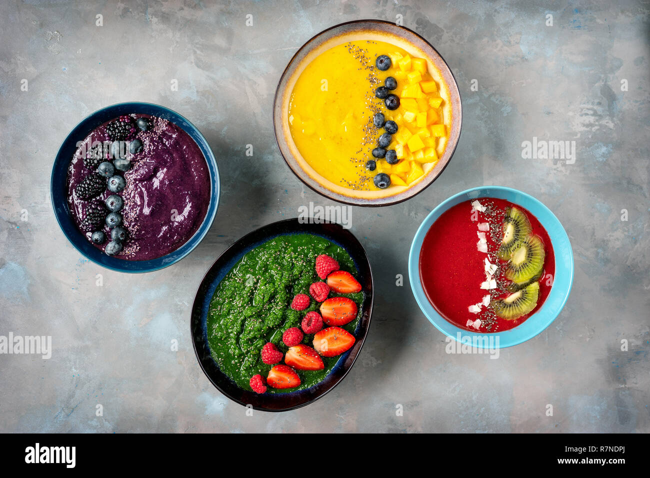 Top view of many plates with colorful fruits smoothie. Superfood ...