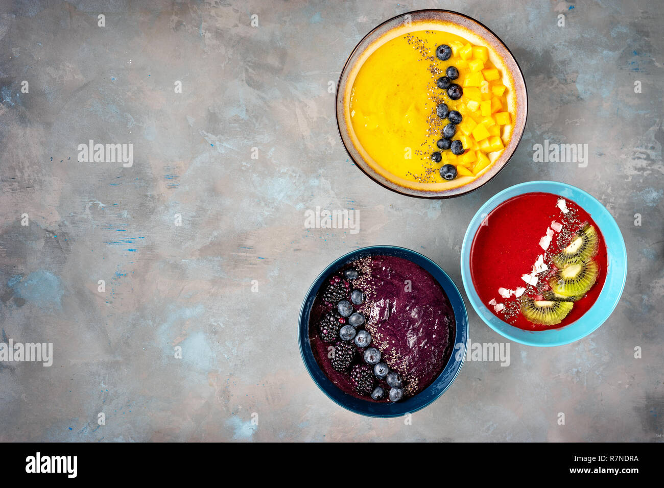 Many plates with colorful fruits smoothie seeing from above Stock Photo ...