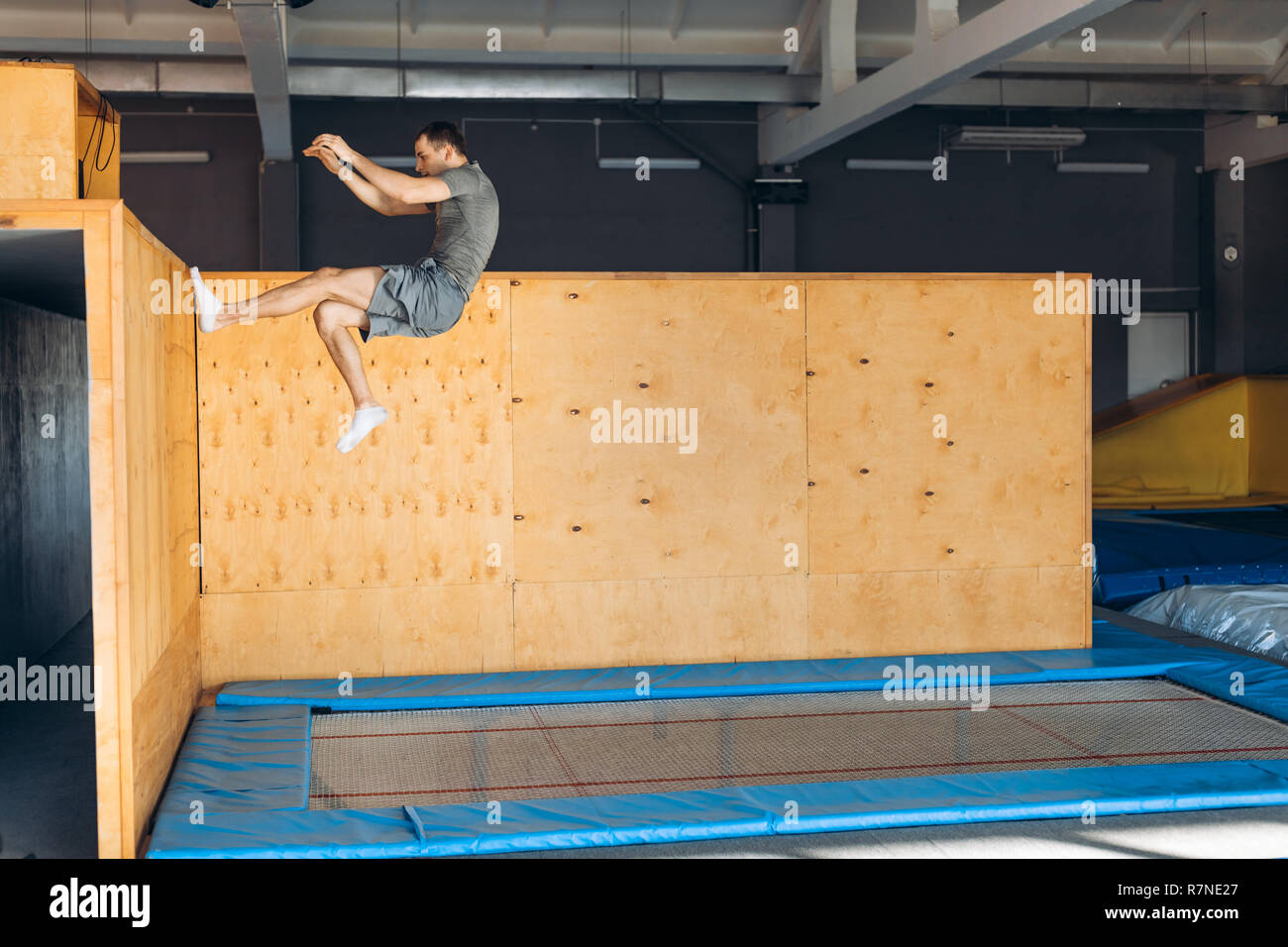young active man doing stunts with wall Stock Photo - Alamy