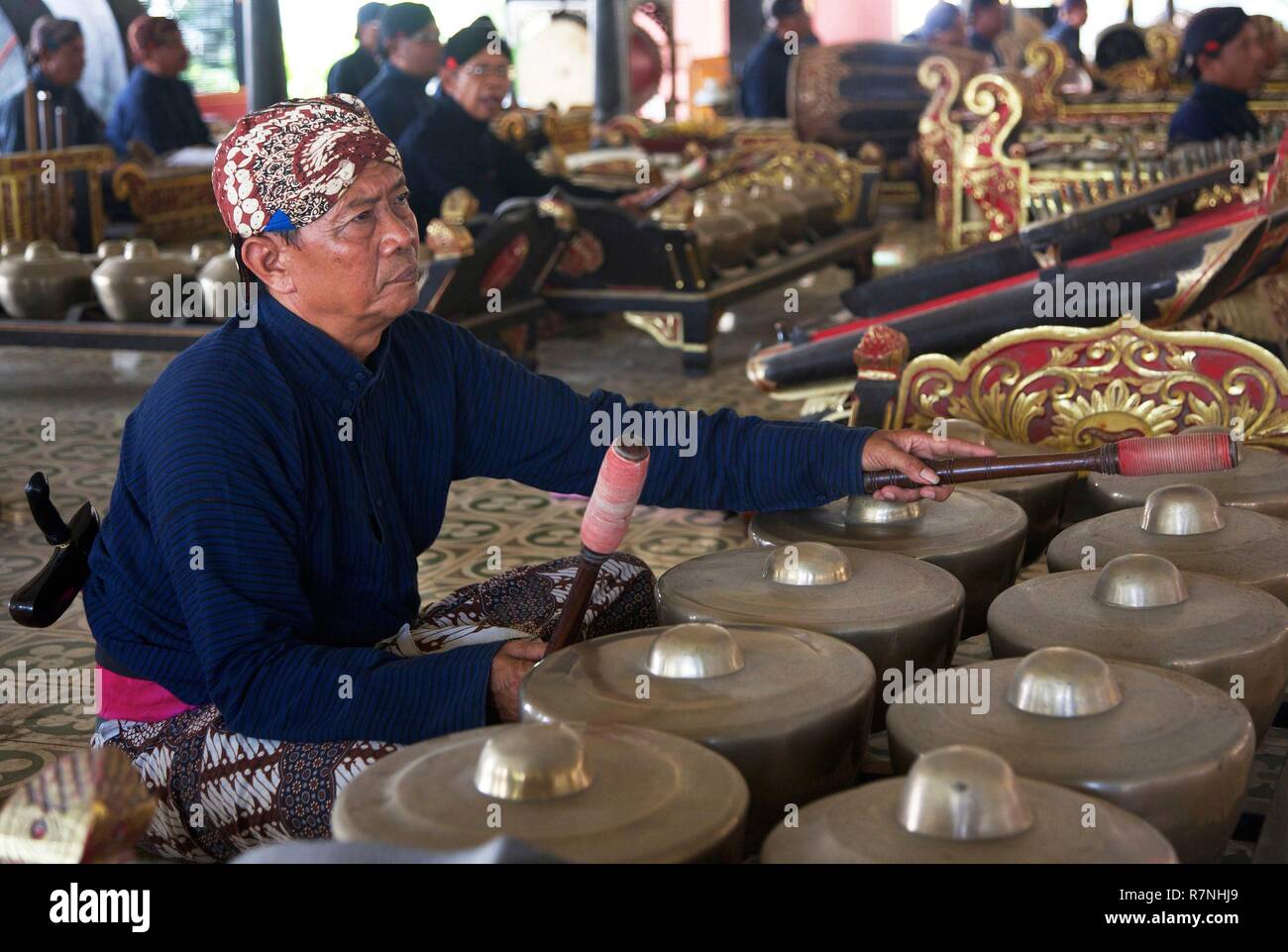 Indonesia, Java, Yogyakarta, Player of gamelan in traditional dress in ...