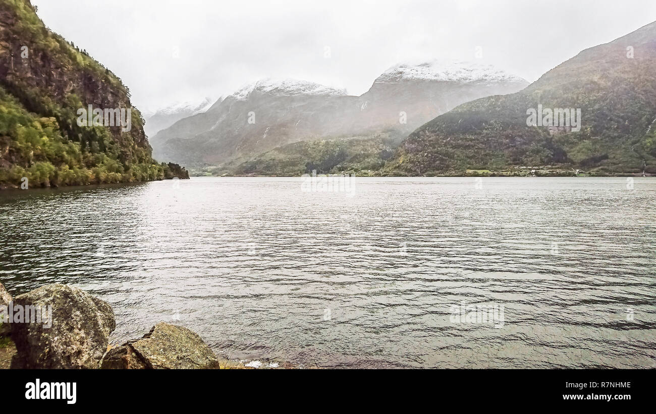Beautiful fjord in autumn twilight, mountain peaks with first snow ...