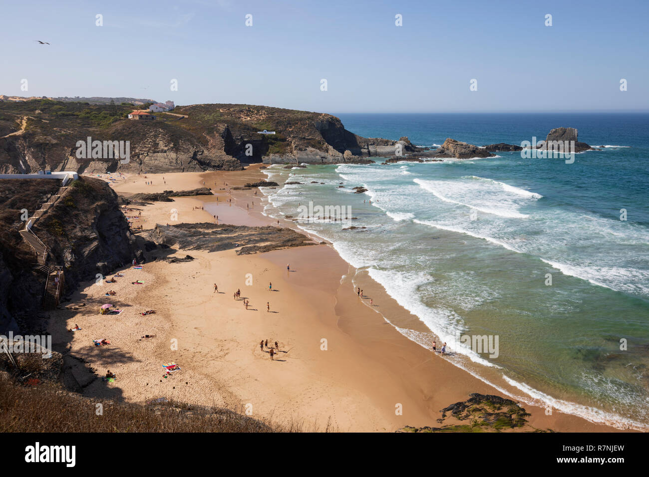 Atlantic waves breaking on sandy beach in the morning sun, Zambujeira ...