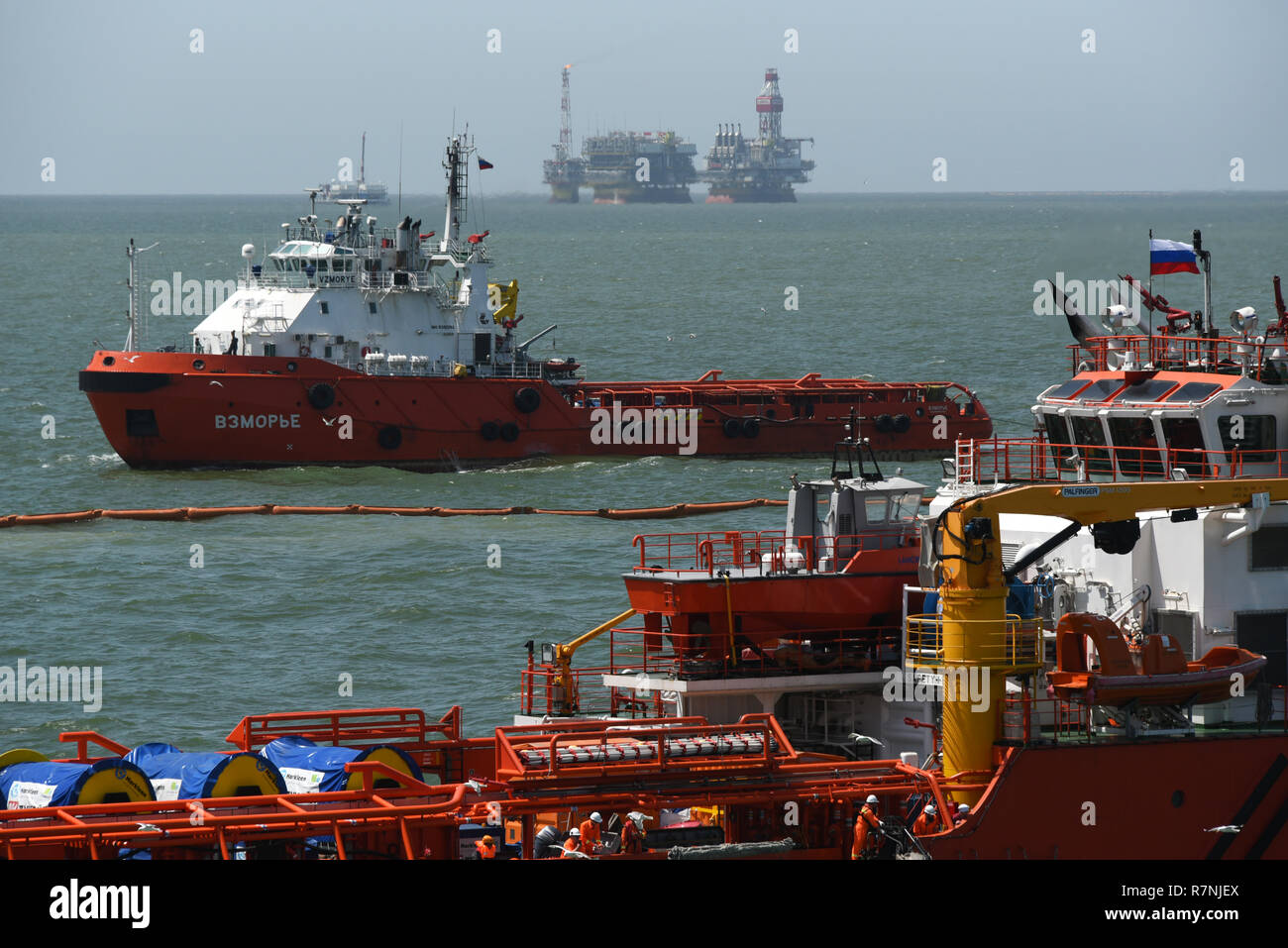 Rescue ships deploy a marine boom during the fire fighting training ...