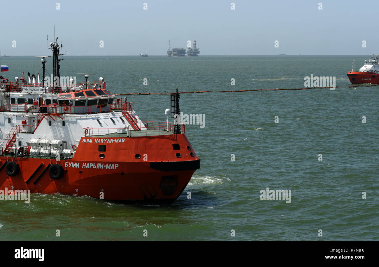 Rescue ships deploy a marine boom during the fire fighting training ...