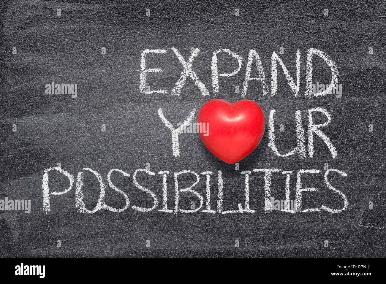 expand your possibilities phrase written on chalkboard with red heart ...