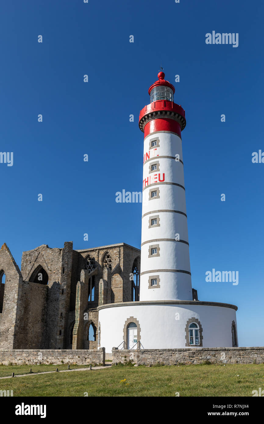 The Saint-Mathieu lighthouse with the ruins of the abbey Saint-Mathieu ...