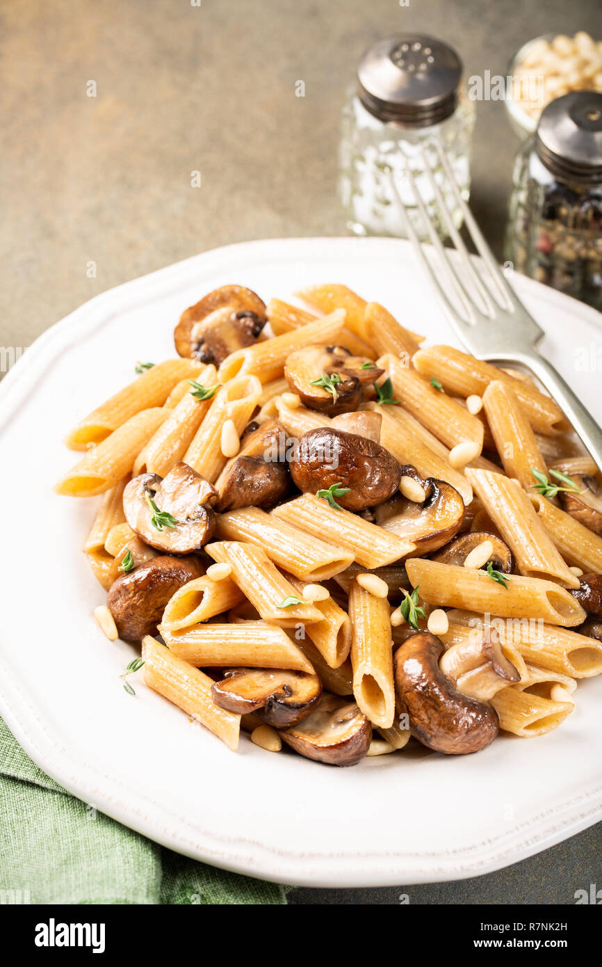 Fancy organic whole grain penne pasta with champignons, pine nuts and ...