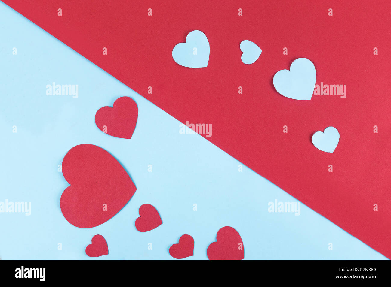 Love concept. Heart cut outs in dual colored background Stock Photo - Alamy