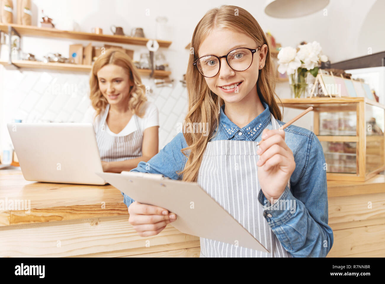 Smart teenage girl taking order in cafe Stock Photo - Alamy