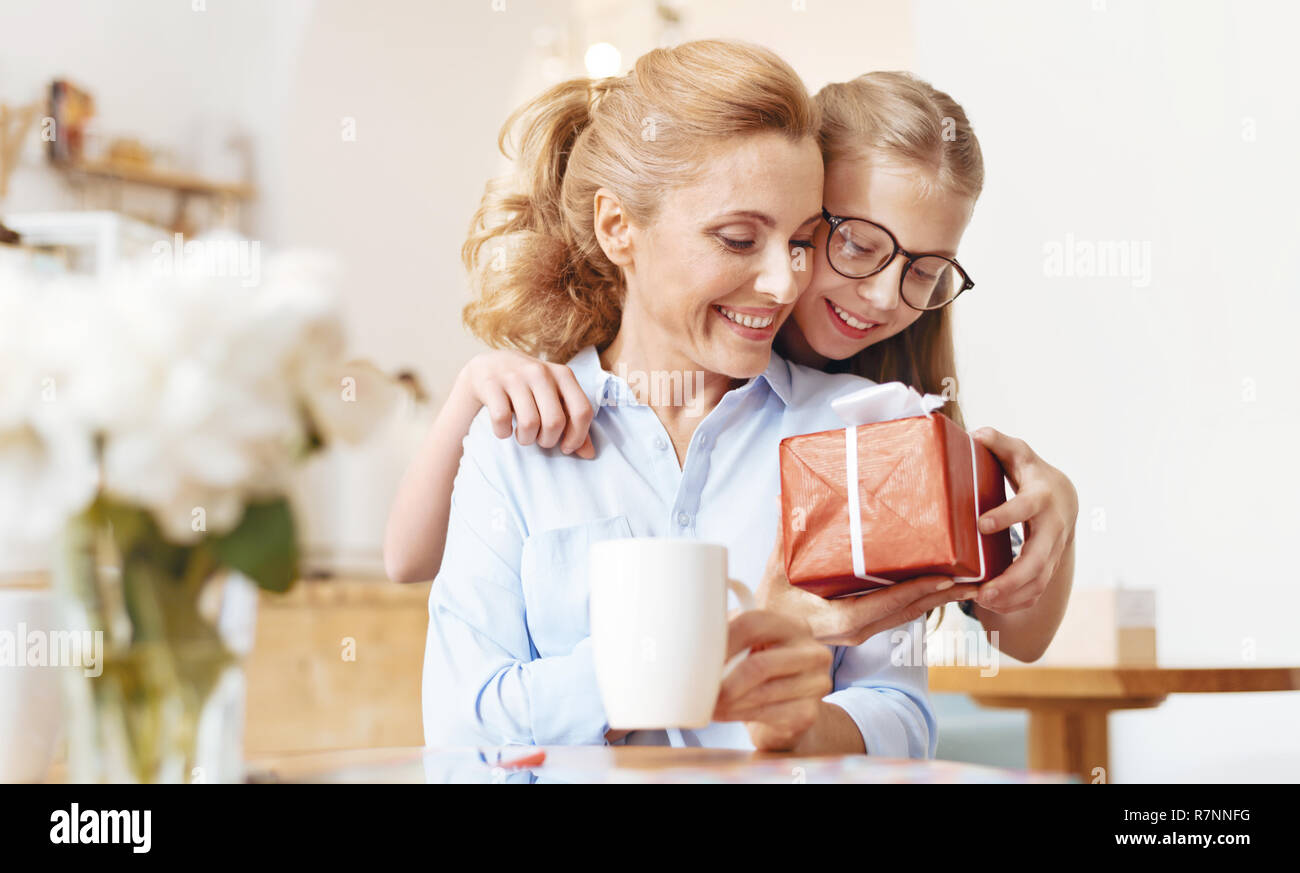 Mother congratulating daughter giving hi-res stock photography and ...