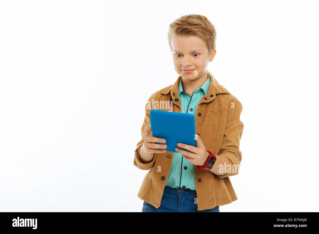 Cheerful positive boy using a new tablet Stock Photo - Alamy
