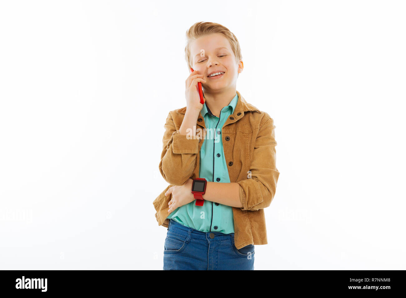 Cute cheerful boy talking on the phone Stock Photo - Alamy