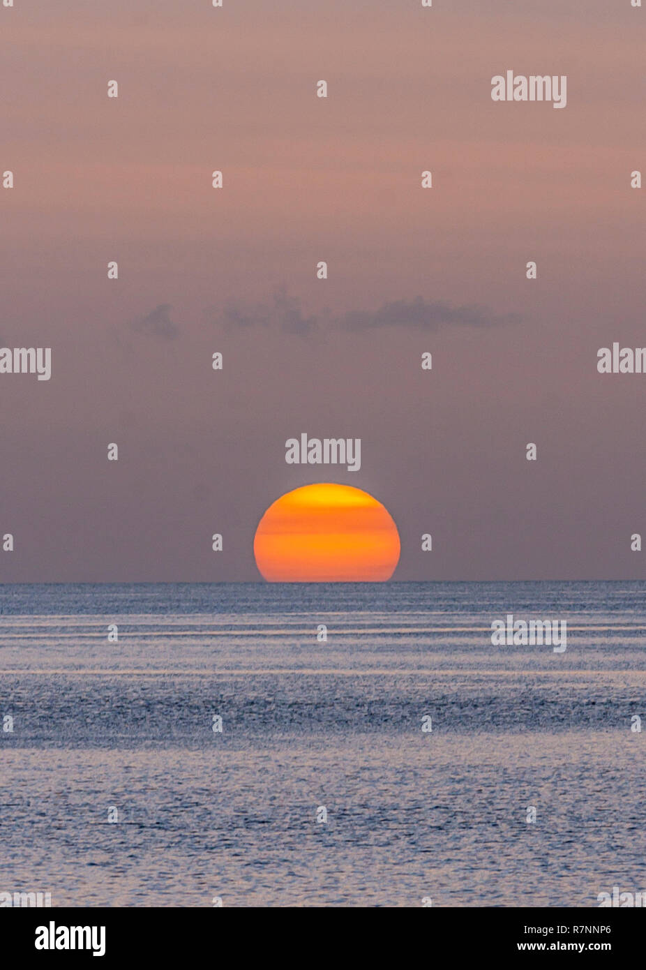 Sunset off the coast the island of Dominica in summer Stock Photo - Alamy