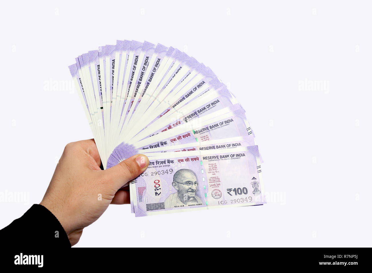 Hand showing spread of new purple notes of Indian currency . Isolated ...