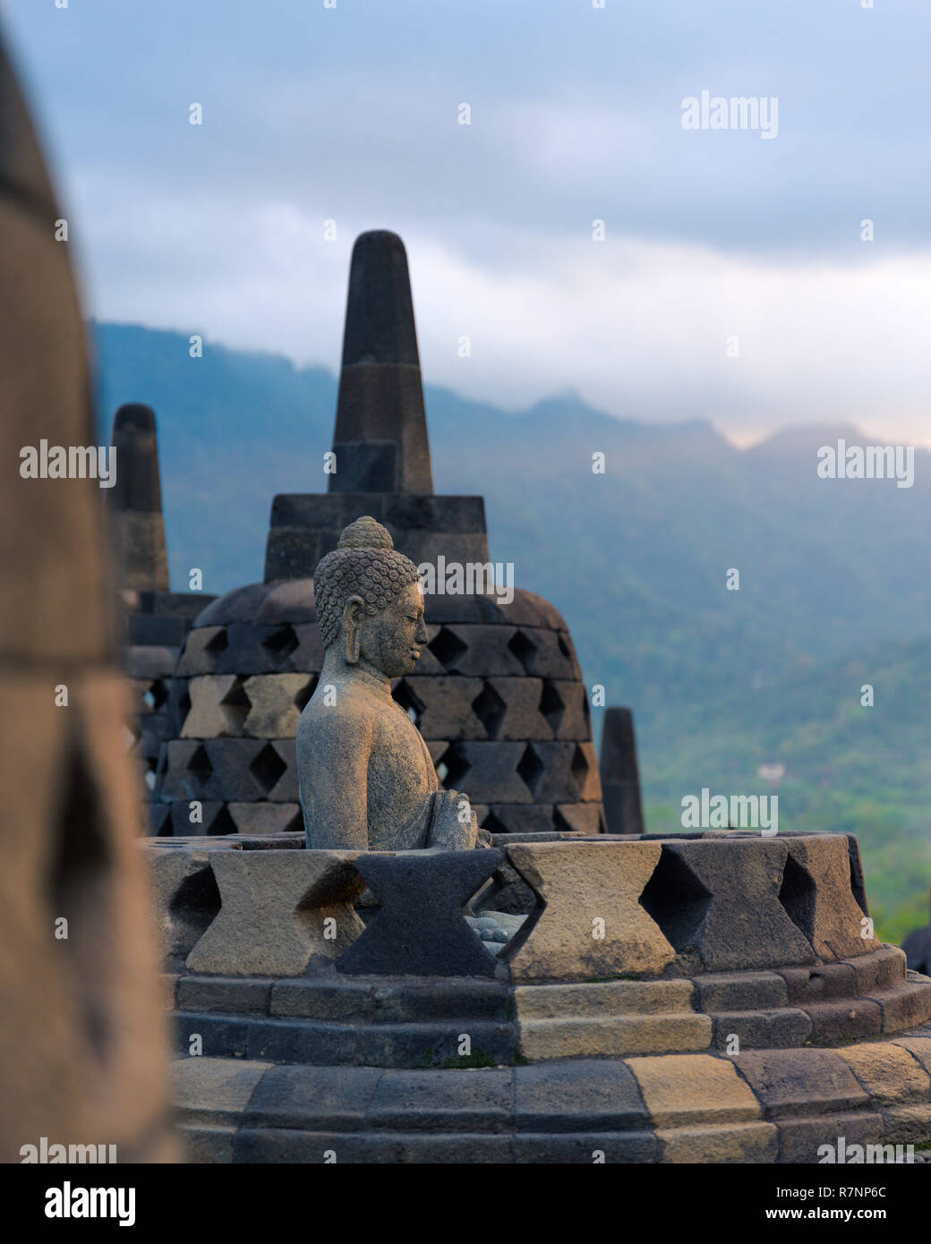 A Buddha stone statue enshrined into a bell shaped stupa looks over the ...