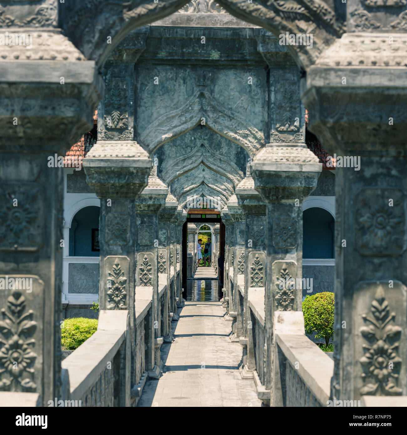 Tourists appear in the perspetive of the arched bridge and central ...