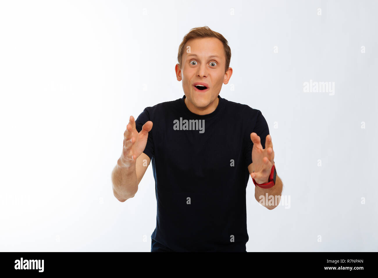 Happy nice young man expressing his surprise Stock Photo - Alamy