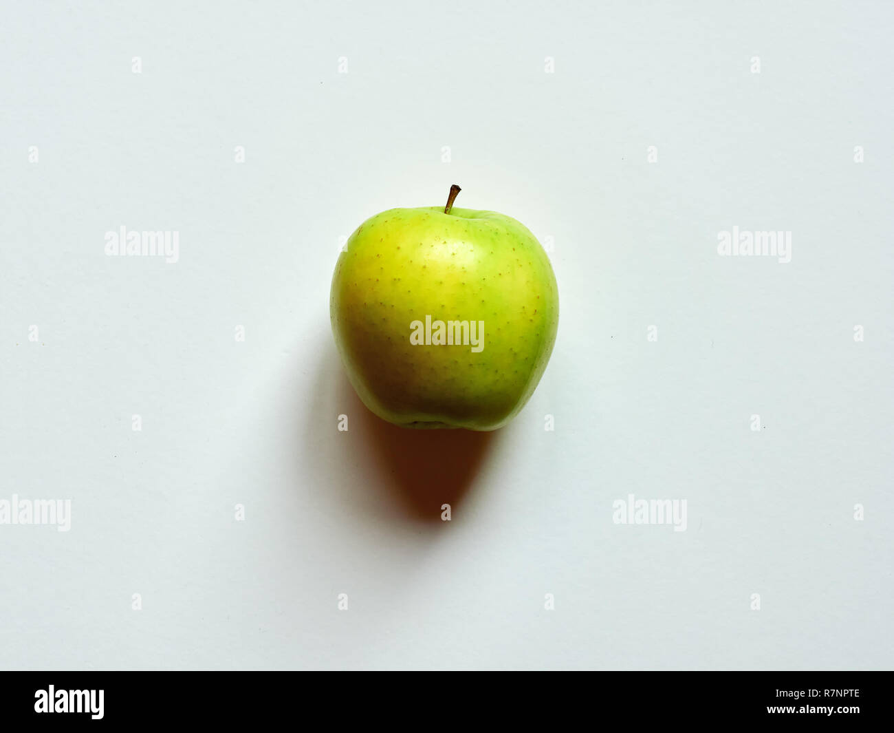 Single green apple isolated air frontal view in studio with a white ...