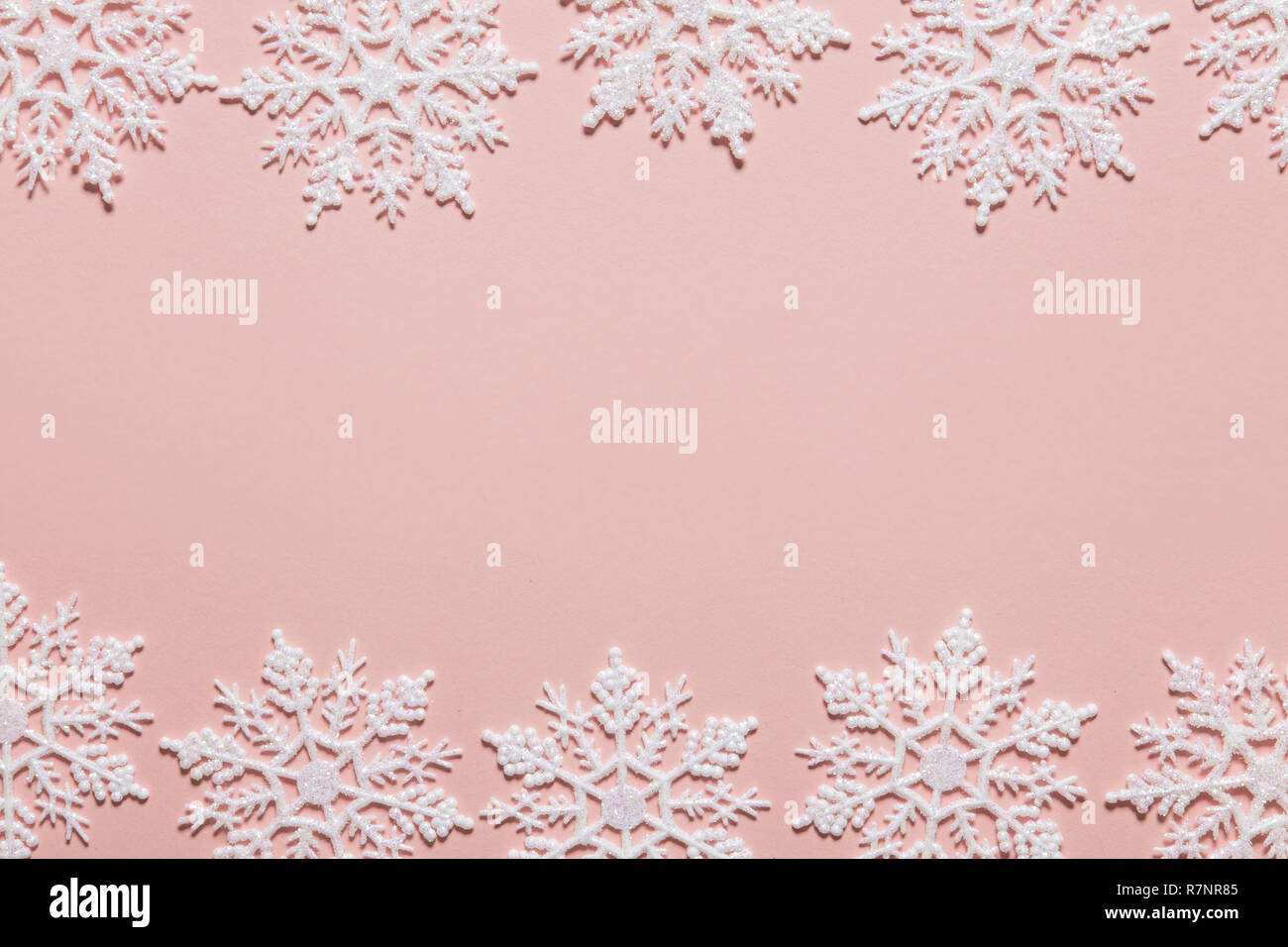 White glitter snowflake composition on a pastel pink background Stock ...