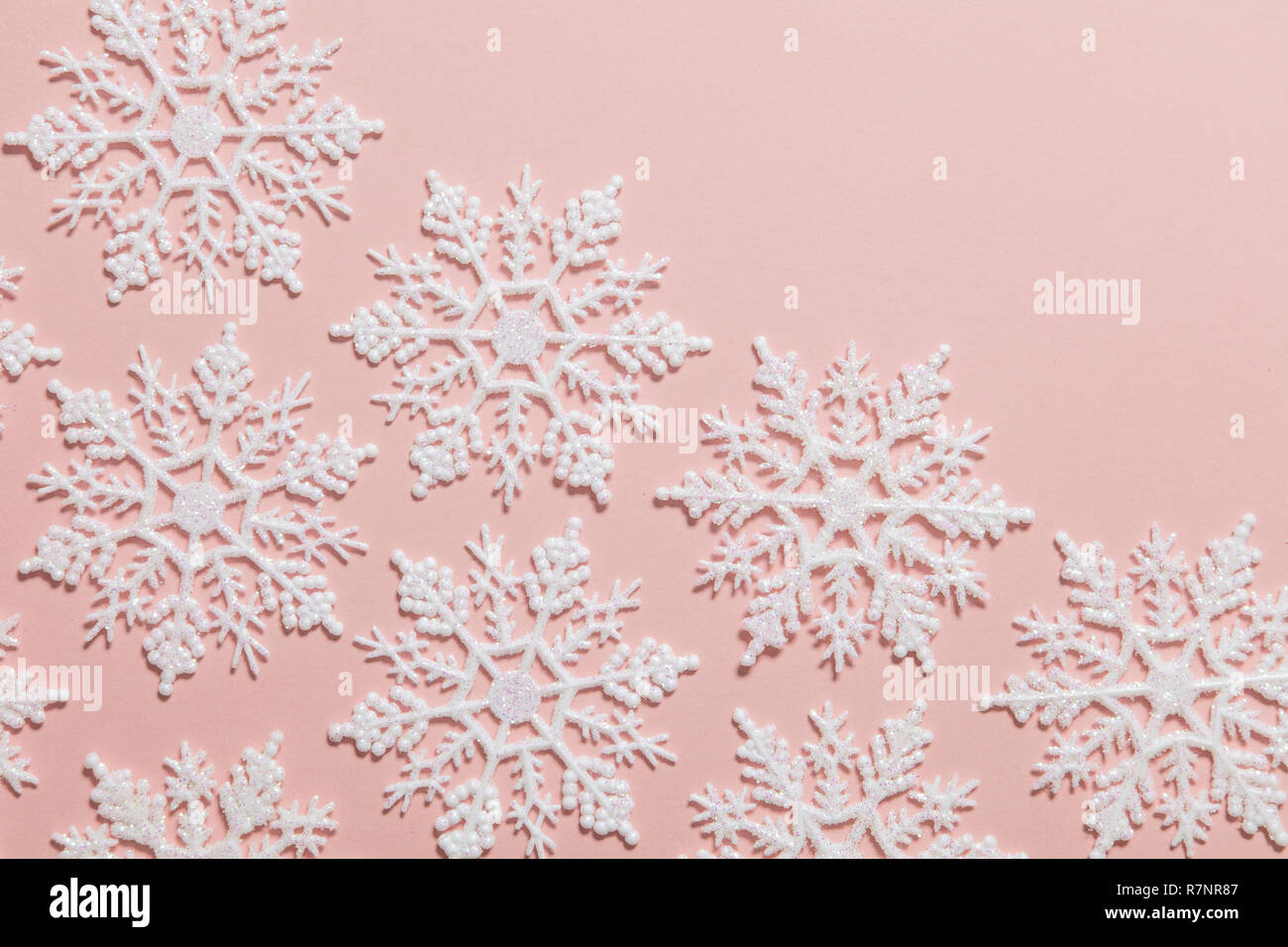 White glitter snowflake composition on a pastel pink background Stock ...