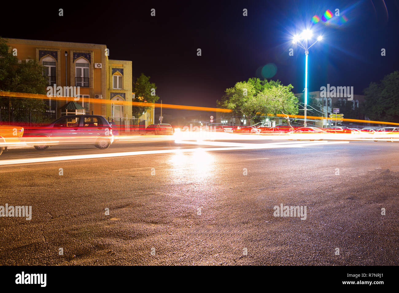 Long exposure image of cars rushing over a highway in the center of ...