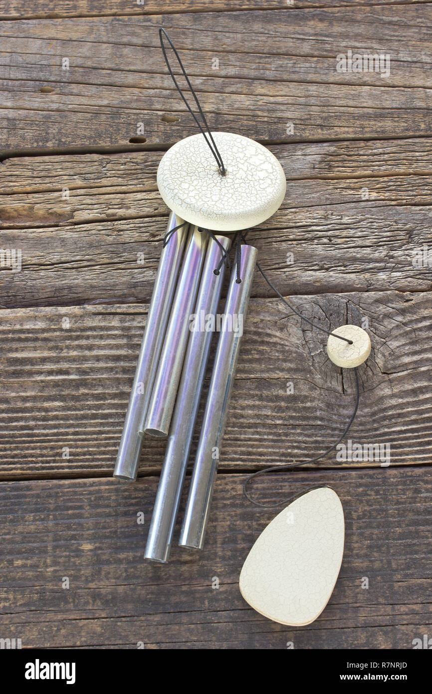 Wind chimes on old wooden background Stock Photo - Alamy