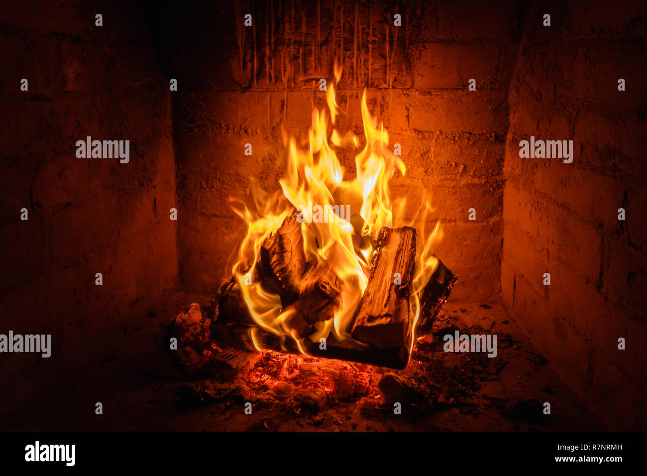 Fire flames in fireplace background Stock Photo - Alamy