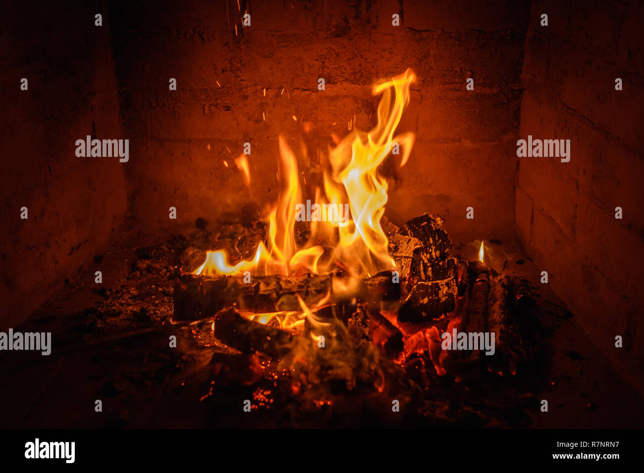 Fire flames in fireplace background Stock Photo - Alamy
