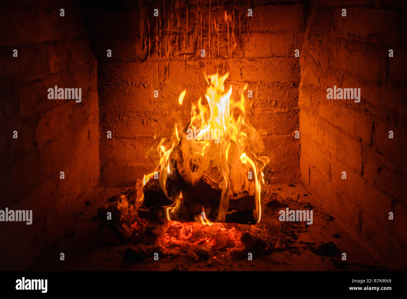 Fire flames in fireplace background Stock Photo - Alamy