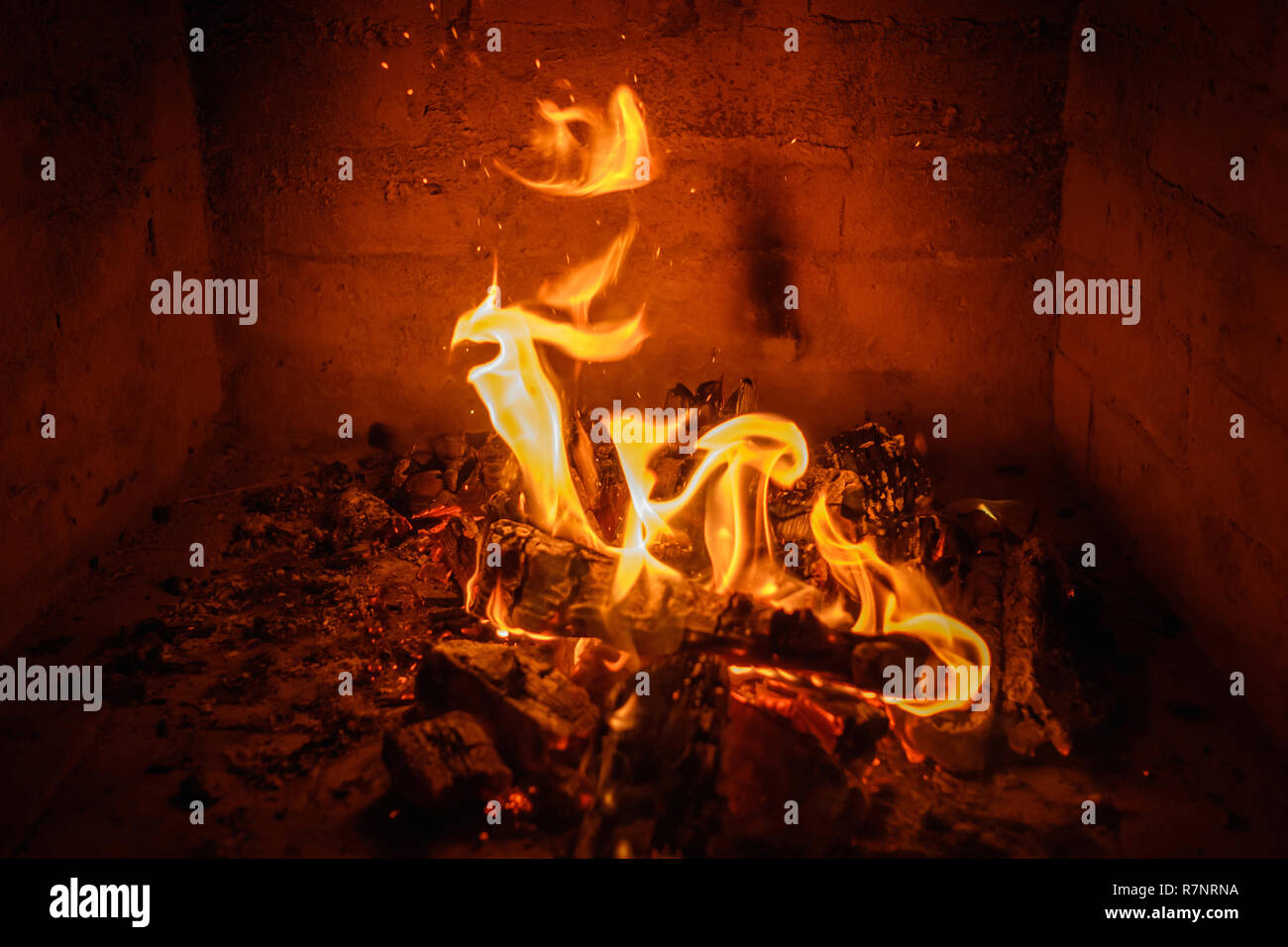 Fire flames in fireplace background Stock Photo - Alamy