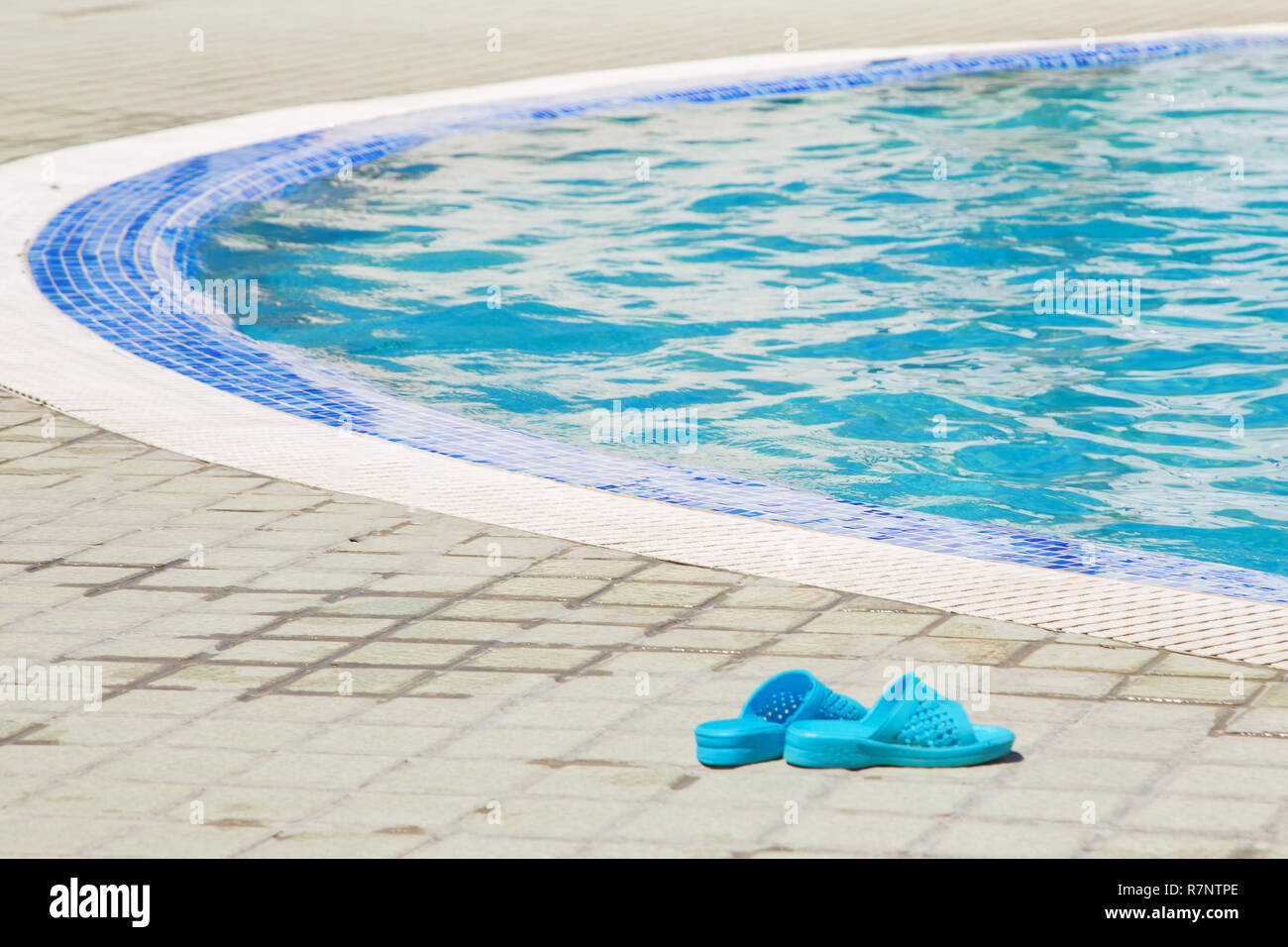 Summer background. Blue sandals by a swimming pool Stock Photo - Alamy