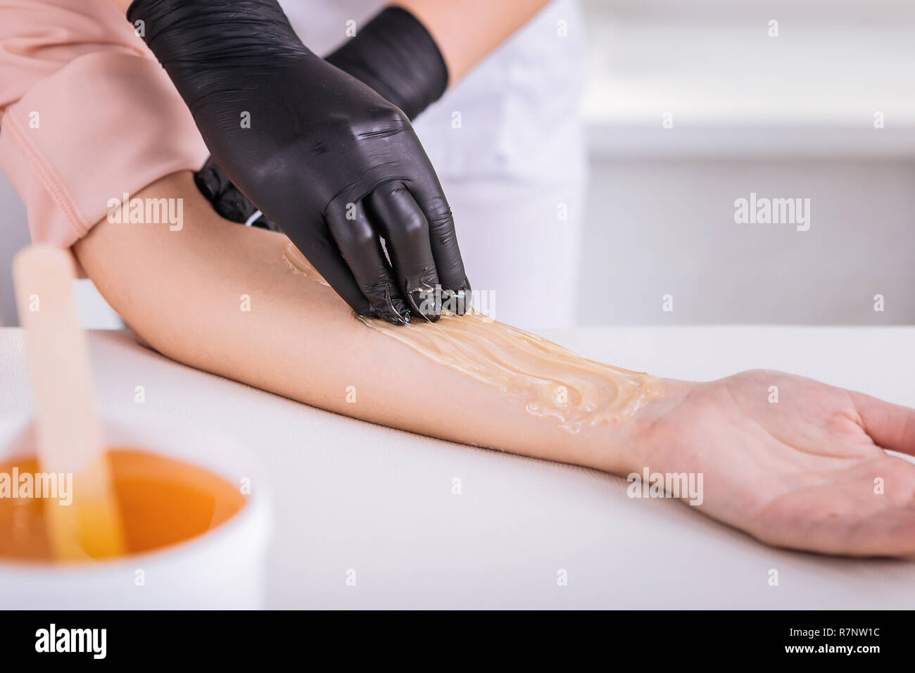 Close up of master in hair removal using depilatory wax Stock Photo - Alamy