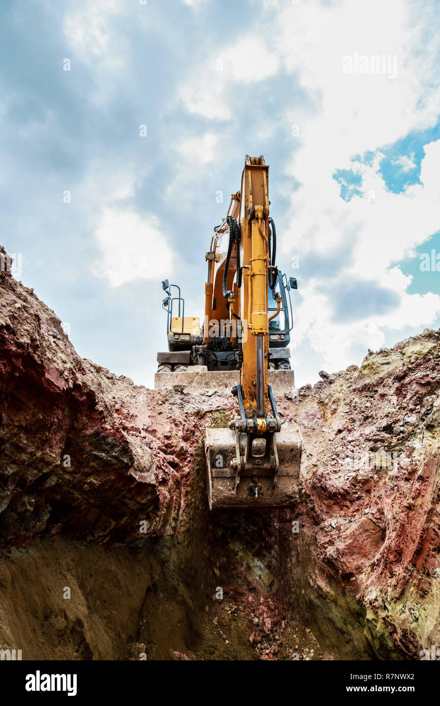 Excavator digging a trench for the pipeline. Excavation Stock Photo - Alamy