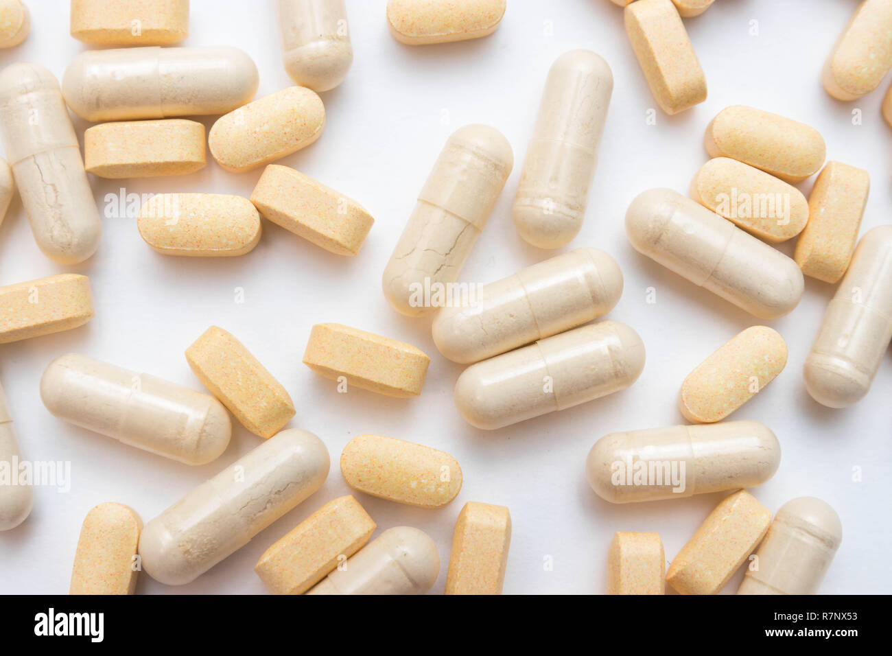 Medicine yellow pills or capsules on a white background close-up ...