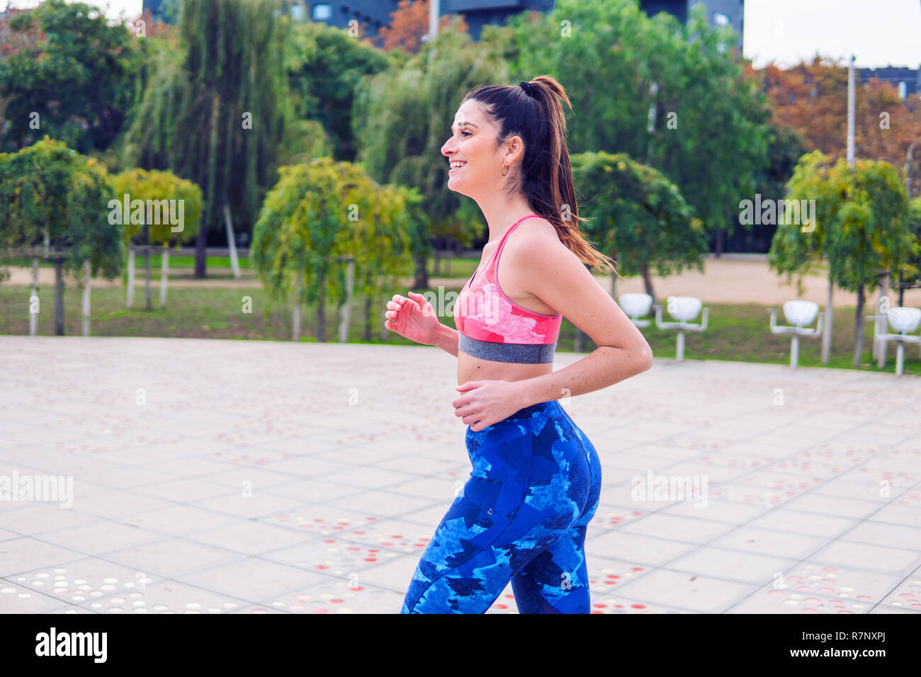 Young beautiful fit woman is running in the park. Healthy concept Stock ...