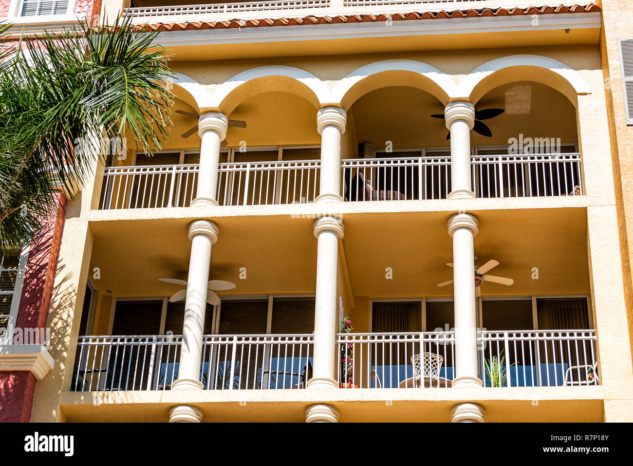 Condos, condominiums colorful, orange yellow columns building facade ...