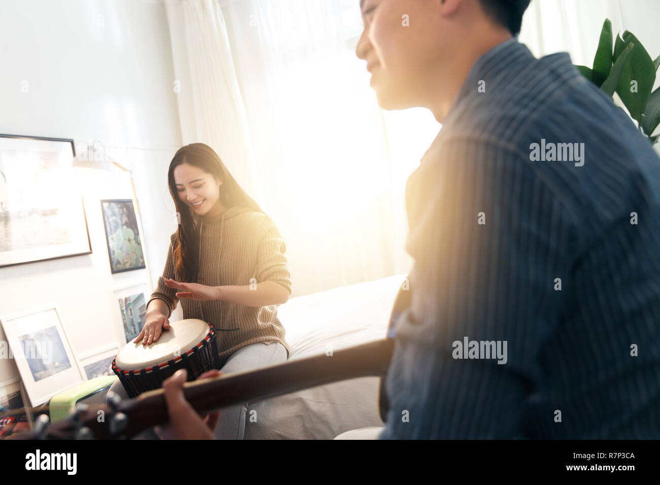 Happy couples playing Musical Instruments at home Stock Photo - Alamy