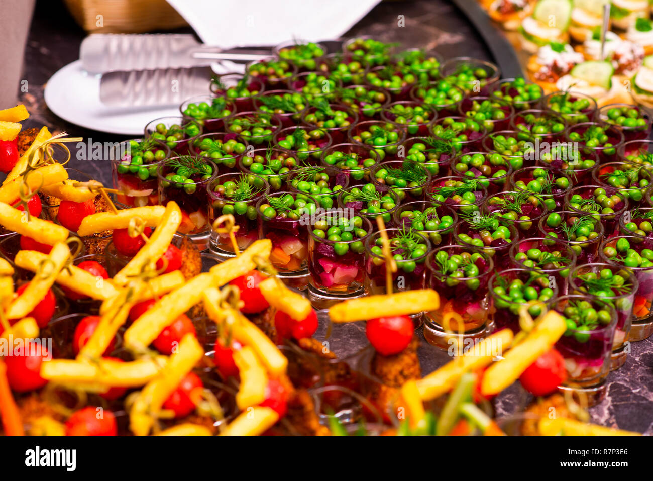 canapes and cold appetizers on the buffet table, meat, vegetables and ...