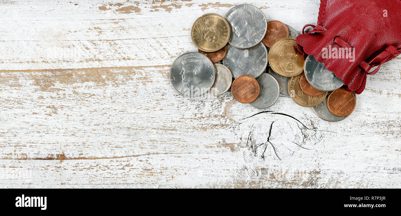 Bag of United States coins on white rustic wood Stock Photo - Alamy
